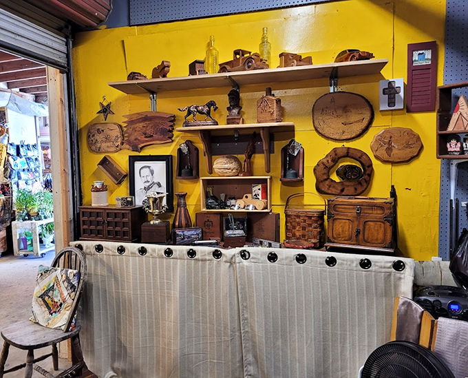 Rustic wooden treasures against a sunshine-yellow wall—where handcrafted nostalgia meets Florida home décor in warm, earthy tones.
