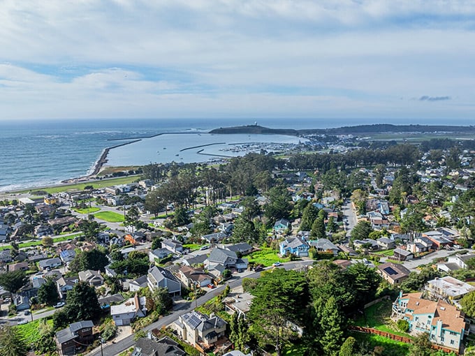 From above, El Granada reveals its clever design – a community embraced by hills on one side and ocean on the other, like California's perfect hug.