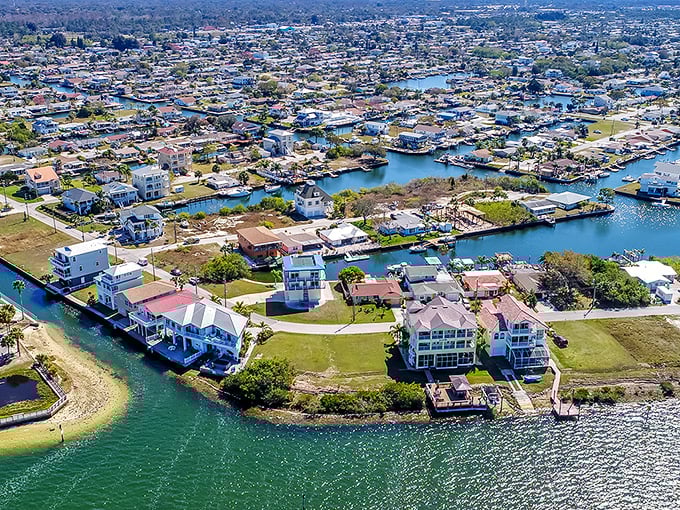 This aerial view reveals Hudson's canal system—where waterfront living doesn't require winning the lottery or marrying a tech billionaire.