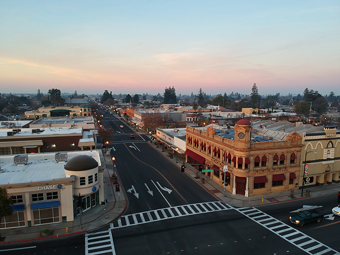 Sunset bathes downtown in golden light, revealing Oakdale's architectural character—where historic buildings aren't museum pieces but living, breathing businesses.
