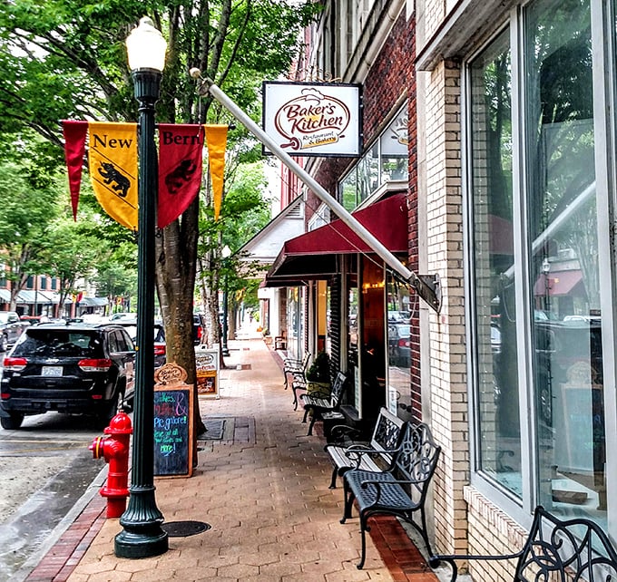 Baker's Kitchen Restaurant beckons hungry visitors with its inviting storefront. Those sidewalk benches aren't just seating—they're front-row tickets to the parade of small-town life.