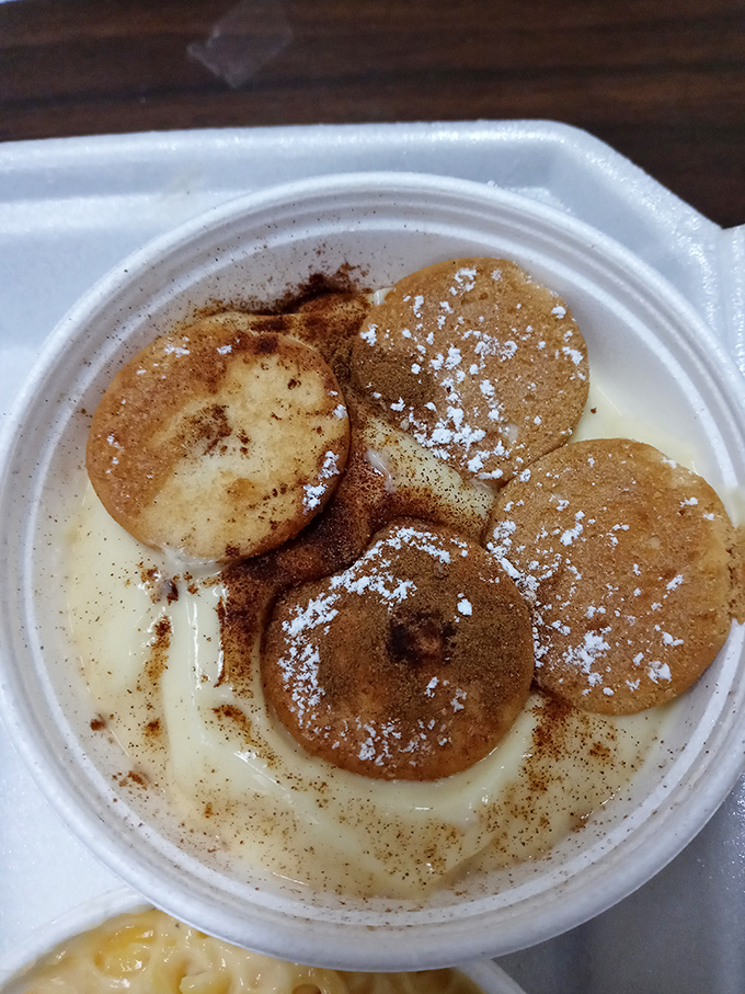 Banana pudding that whispers "save room for dessert"—vanilla wafers, creamy pudding, and a dusting of cinnamon that says "I care."