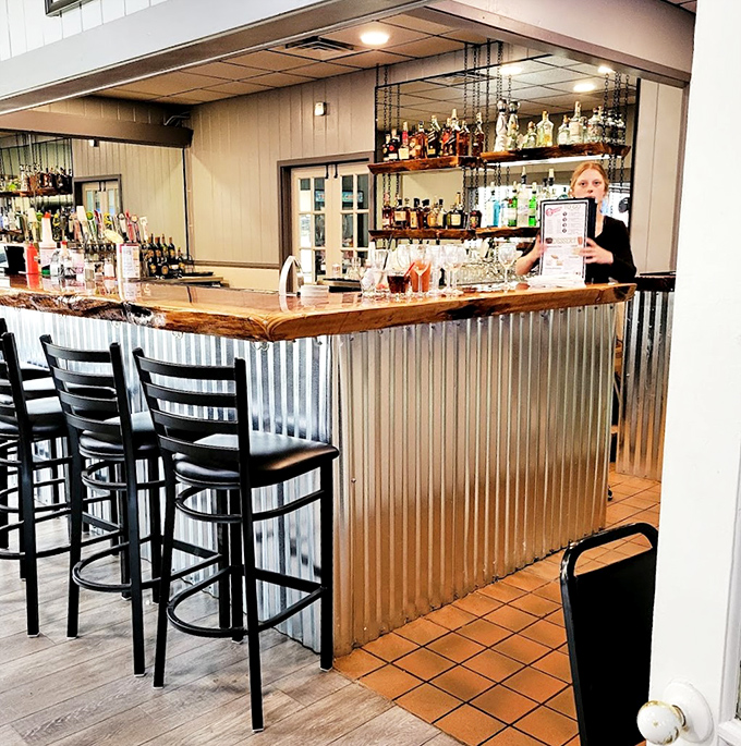 The bar area strikes that perfect balance—enough bottles to promise a good time, but still the kind of place where nobody's judging your drink order.