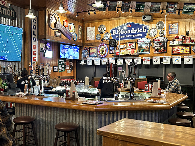 The bar area doesn't just serve drinks; it's a shrine to sports memorabilia where beer taps stand ready to extinguish the sweet fires of BBQ spice.
