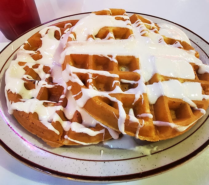 A Belgian waffle wearing its Sunday best – dressed in cream that's melting like your resolve to "just have a bite."