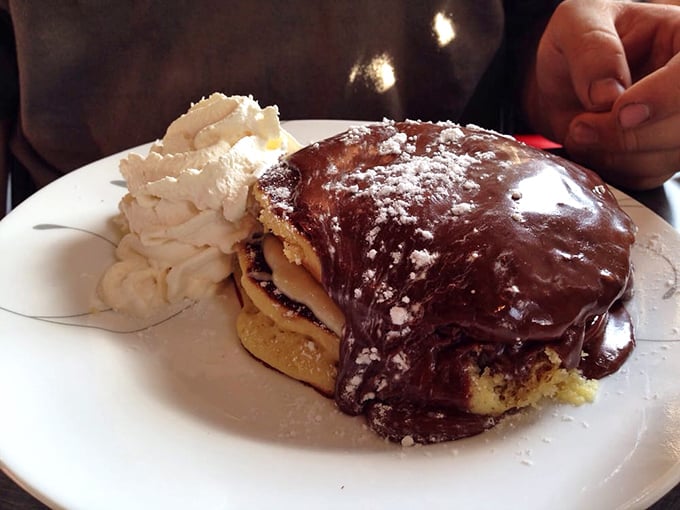 Boston cream pancakes that blur the line between breakfast and dessert. The chocolate sauce isn't asking permission—it's making a statement.