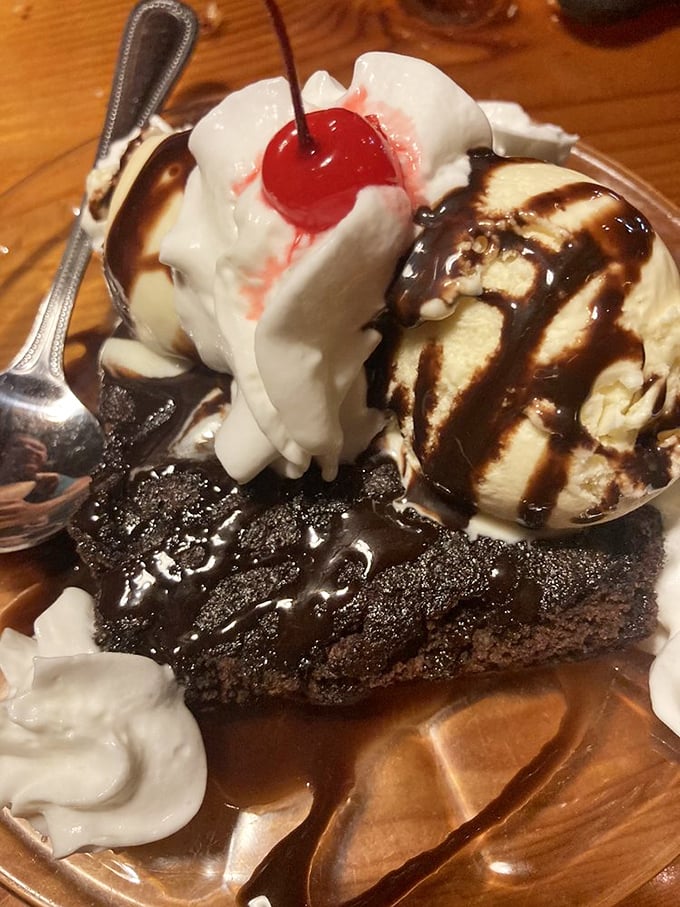 A brownie sundae that doesn't just end your meal—it creates a chocolate exclamation point. The cherry on top isn't just garnish; it's the traditional crown of dessert royalty.
