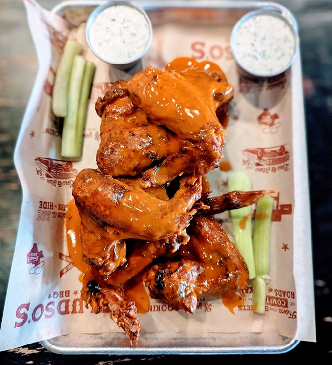 These buffalo wings aren't just coated in sauce—they're baptized in it. The celery sticks aren't garnish; they're necessary cooling agents for the flavor inferno.
