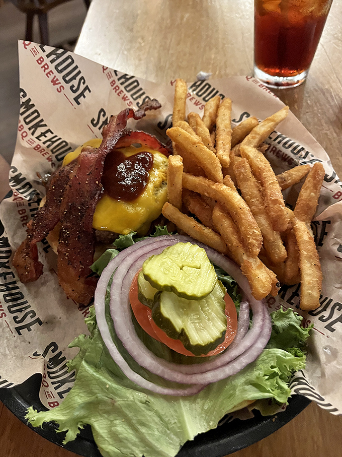 A burger that's dressed for success with all the right accessories. Those fries aren't just side players—they're golden supporting actors in this meal's delicious drama.