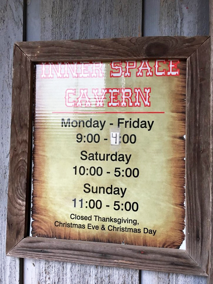 Business hours posted with cave-appropriate burnt edges. Even in the digital age, there's something reassuring about a hand-crafted sign.