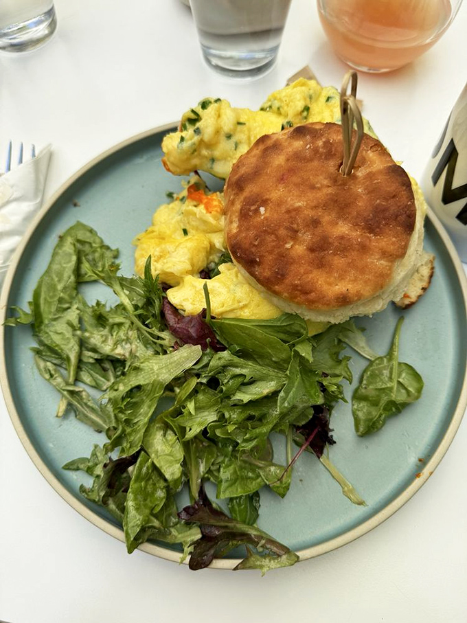 The buttermilk biscuit sandwich—where breakfast dreams come true between layers of flaky, buttery goodness. Worth every crumb.