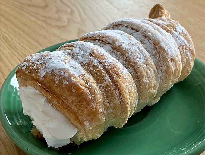 A tray of freshly filled cannoli waiting for their forever homes. Like adoption but caloric – these crispy tubes of joy won't be orphans for long. 
