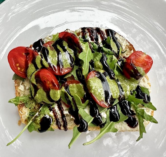 Avocado toast elevated from basic to brilliant with balsamic drizzle and fresh tomatoes—proof that simple ingredients can create extraordinary flavors.