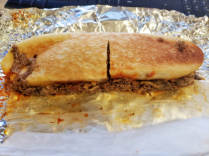 Behold the cheesesteak in its natural habitat—foil-wrapped perfection that makes Philadelphia nervous about its sandwich supremacy.