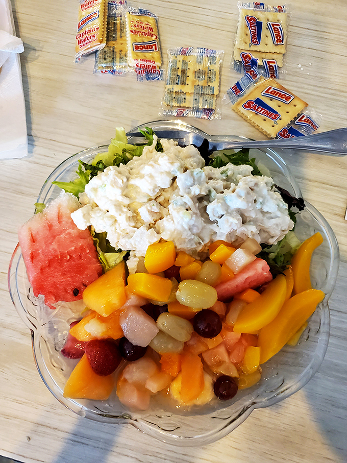 A chicken salad fruit plate that makes healthy eating feel like cheating. Those crackers standing by know they're about to join something special.