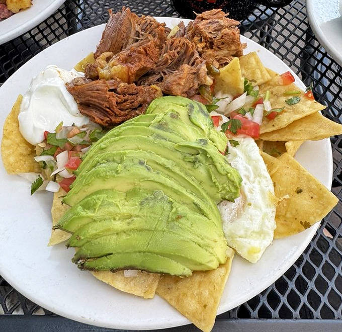 Chilaquiles that make you question why you'd ever eat anything else for breakfast—crispy, creamy, and topped with avocado slices of dreams.