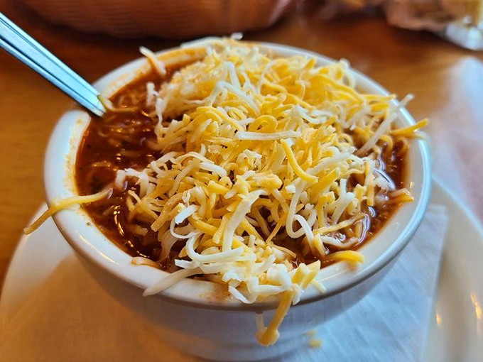 This isn't just chili—it's a warm hug in a bowl, topped with enough cheese to make Wisconsin nervous about its dairy supremacy.