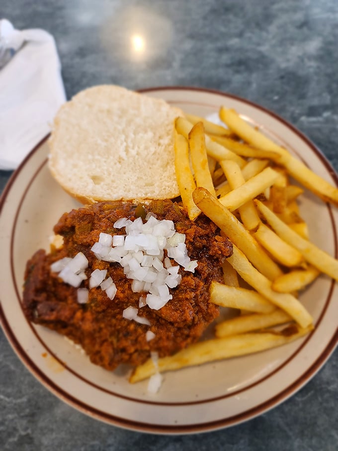 The open-faced chili sandwich with diced onions and fries—when you need a fork for your sandwich, you know you're in for something special.