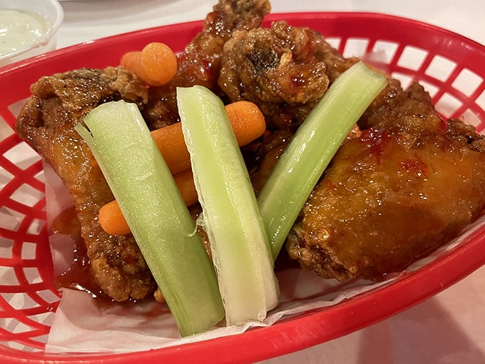 Saucy wings garnished with celery and carrots—a nod to tradition with a flavor punch that demands attention. Buffalo would be proud.