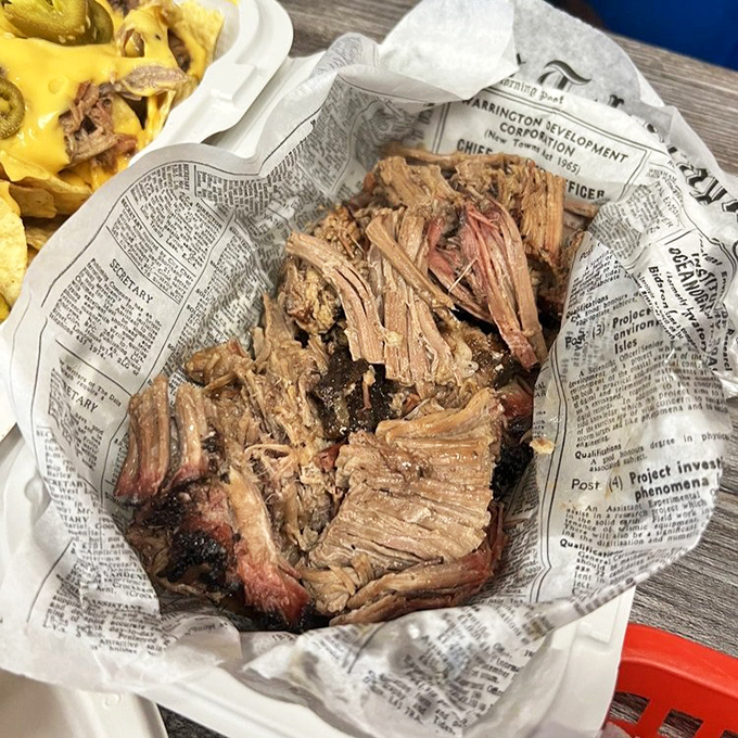 Chopped brisket that looks like it's been kissed by smoke for hours—because it has. Newspaper: not just for reading anymore.