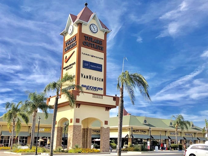 The iconic Tulare Outlets tower against a perfect California sky—a beacon of hope for fashionistas with champagne taste and beer budgets.
