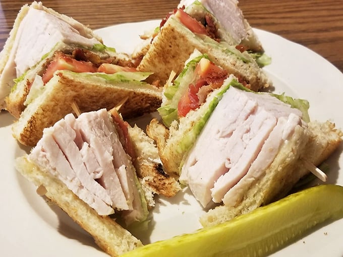 The club sandwich – America's most trustworthy lunch option. Triple-decker architecture that engineers would admire, with a pickle for perspective.