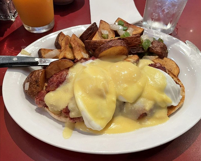 Eggs Benedict reimagined—Canadian bacon and poached eggs lounging beneath a hollandaise blanket that's sunshine on a plate.