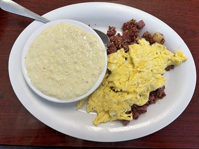 Corned beef hash with grits and eggs—a breakfast trinity that proves heaven exists and it's on this very plate.