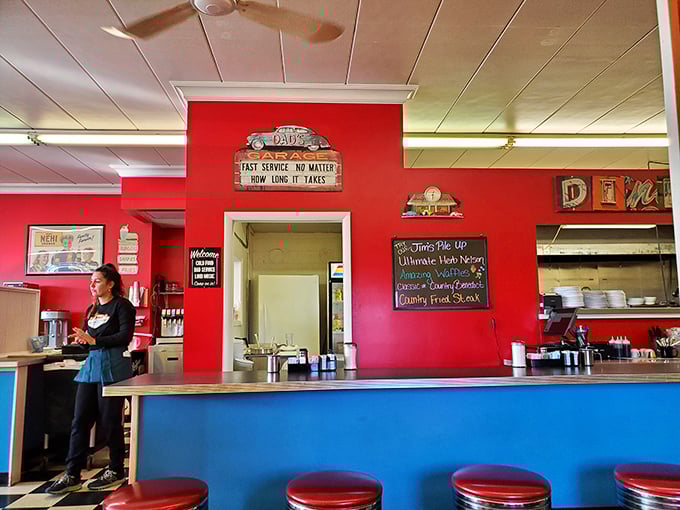 The counter view—where solo diners find community and regulars exchange local news while watching breakfast magic unfold in the kitchen beyond.