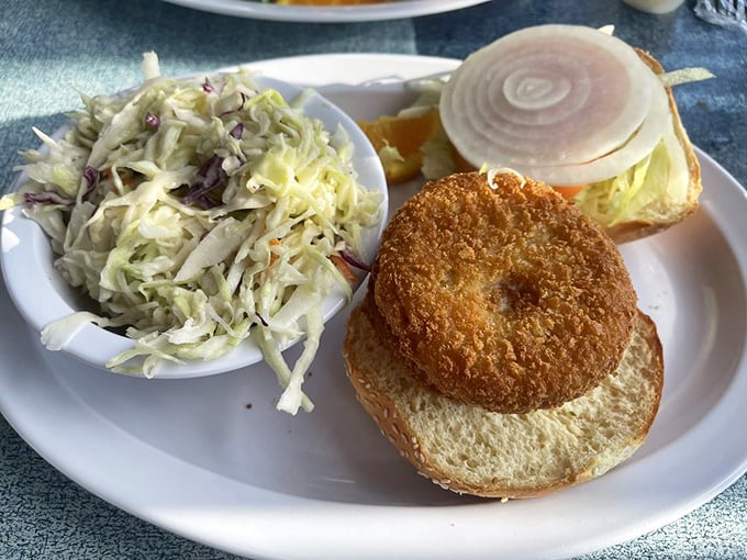 A proper crab cake sandwich that's actually about the crab—not the filler—paired with slaw that knows its supporting role perfectly.