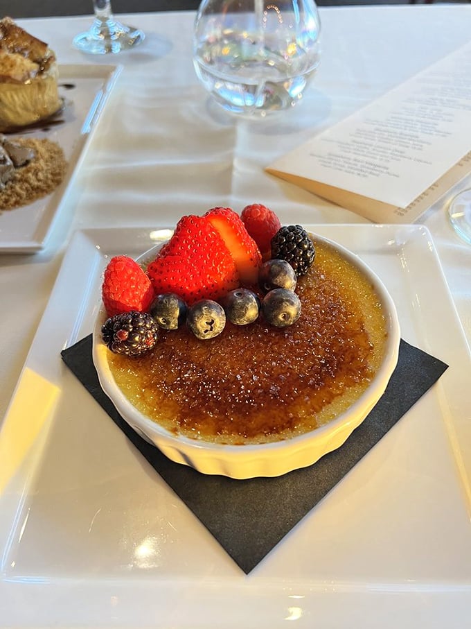 Crème brûlée with fresh berries—because after all that seafood, your sweet tooth deserves its moment in the spotlight too.