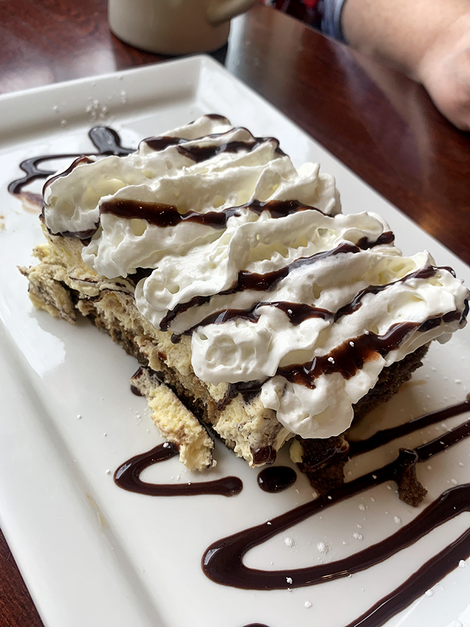 This isn't just dessert—it's a cloud of whipped cream and chocolate drizzle that makes you wonder why you ever considered saving room.