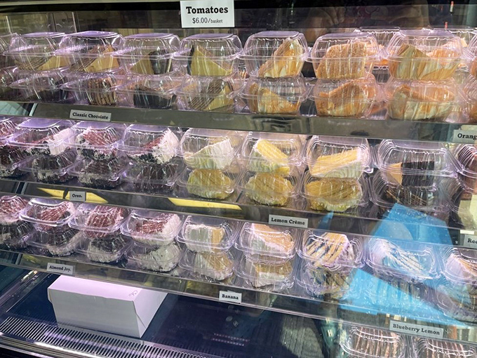 Rows of colorful cake slices await, from chocolate to lemon crème, making it impossible to choose just one.