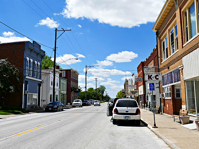 Downtown Nauvoo stretches toward the horizon under a perfect Midwestern sky, its colorful buildings like a real-life watercolor painting of small-town America.