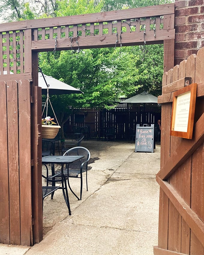 This garden gate entrance isn't just an opening to a patio – it's a portal to the kind of afternoon that makes you forget to check your phone.