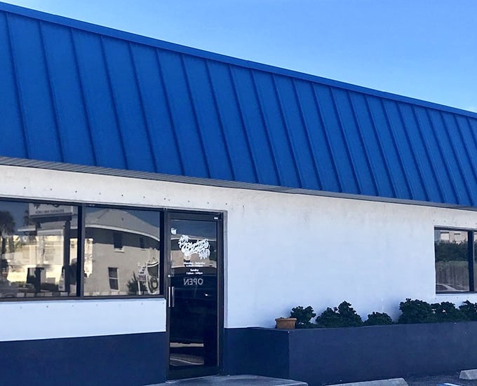 Simple blue-roofed entrance hiding extraordinary culinary treasures. Like finding a portal to breakfast heaven disguised as a modest building.