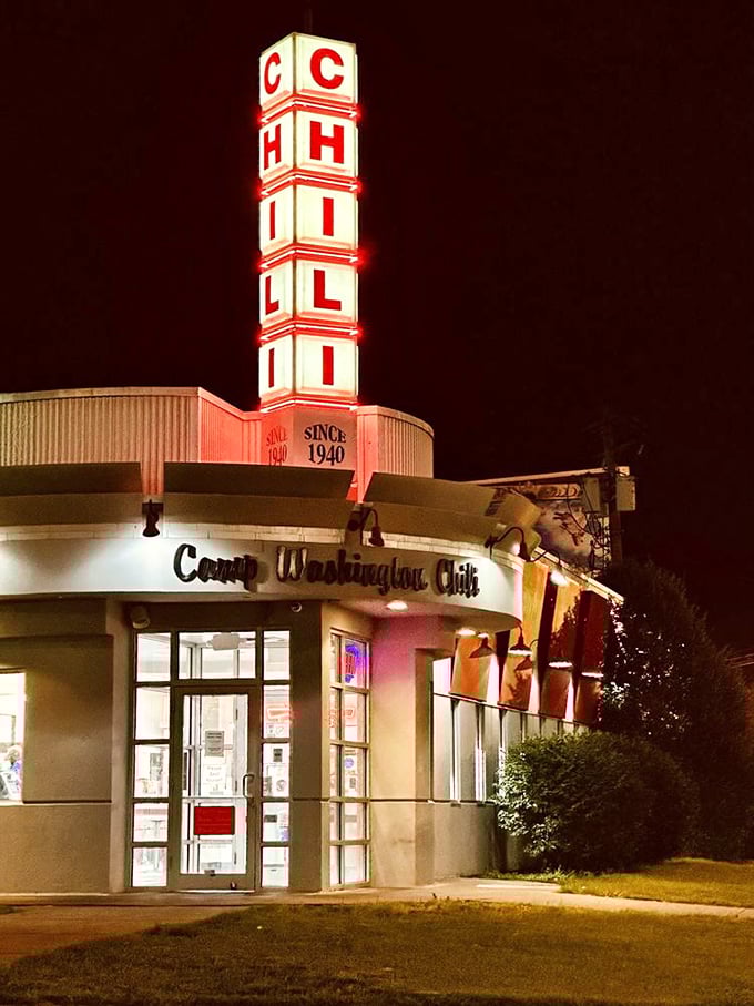 By night, the neon CHILI sign transforms into a beacon of hope for the hungry, promising 24-hour comfort in a chaotic world.