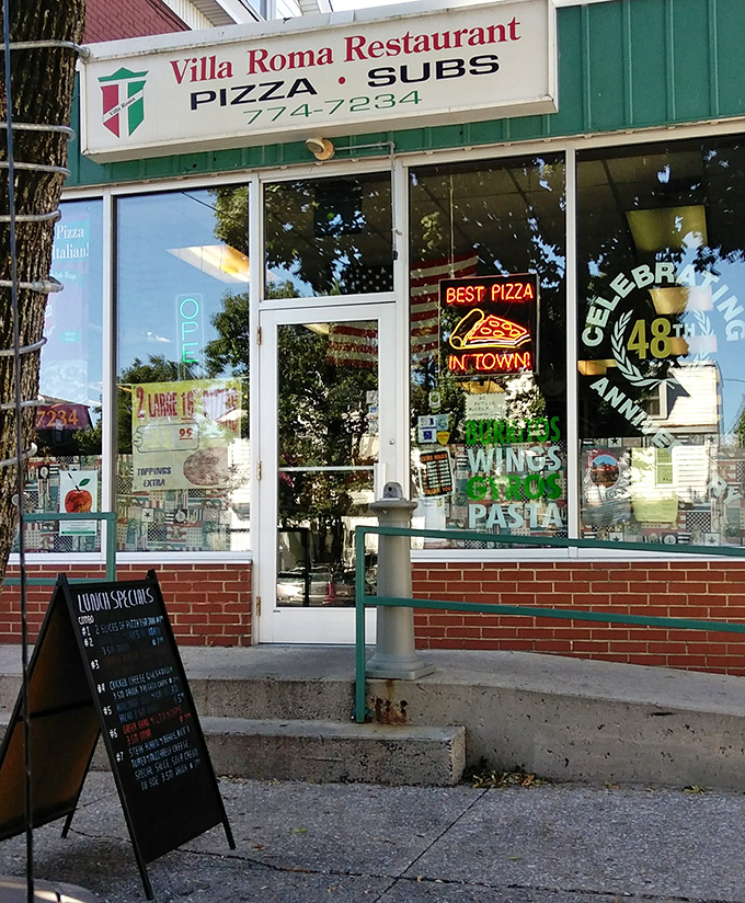 The entrance to paradise isn't pearly gates – it's a glass door with a neon "OPEN" sign and the promise of perfect pizza within.