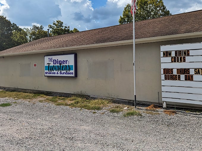 The side view reveals a humble establishment with a marquee announcing burger specials—a roadside beacon for comfort food seekers.