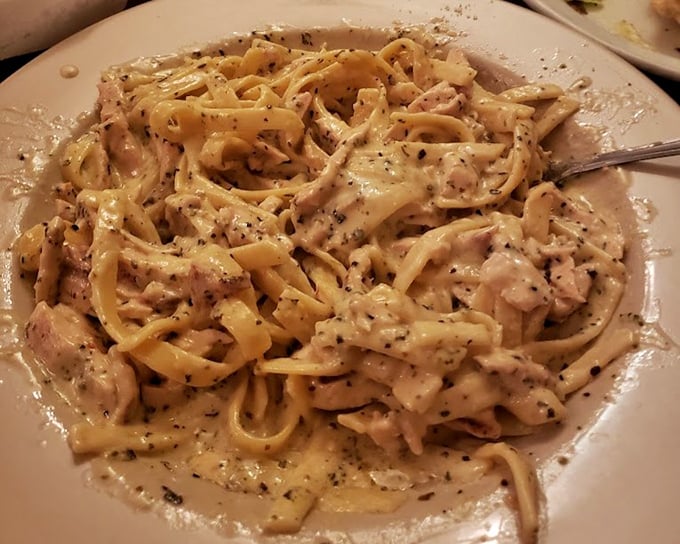 This fettuccine doesn't just sit on the plate—it lounges luxuriously in its creamy sauce, like it's at a day spa for pasta.