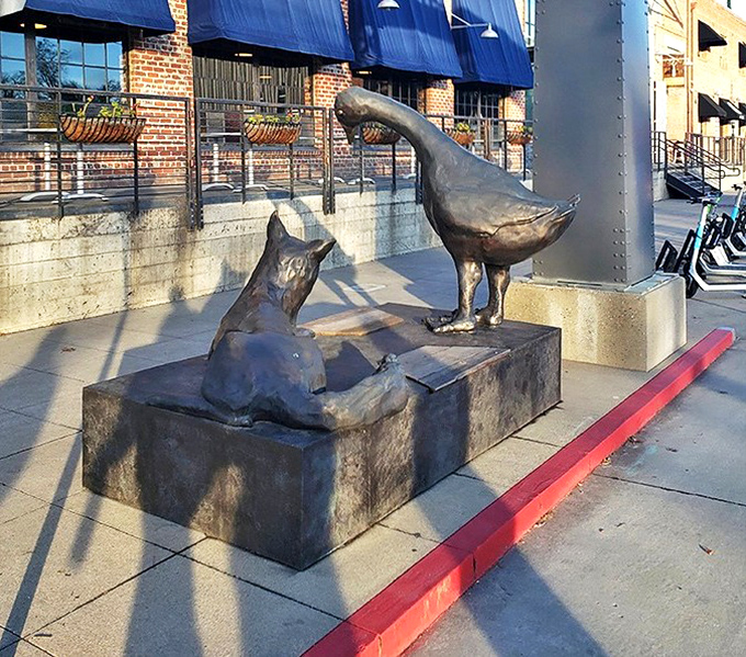 Fox and Goose immortalized in metal – a whimsical nod to the pub's namesake that stands guard outside like a quirky British sentinel.