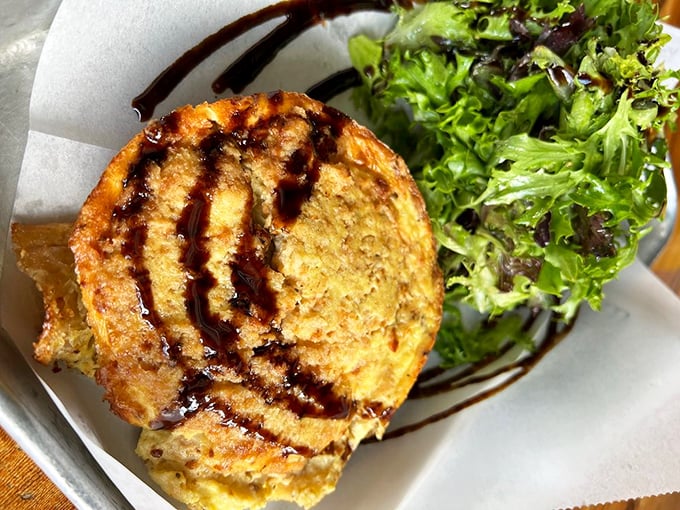 This isn't your grandmother's quiche—unless your grandmother was a culinary genius. The golden disk drizzled with balsamic sits beside fresh greens like edible art.