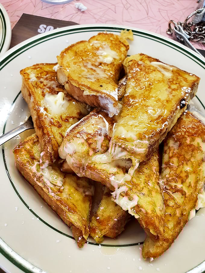 French toast that's dressed better than most people on vacation—golden, buttery, and absolutely dripping with sweet surrender.