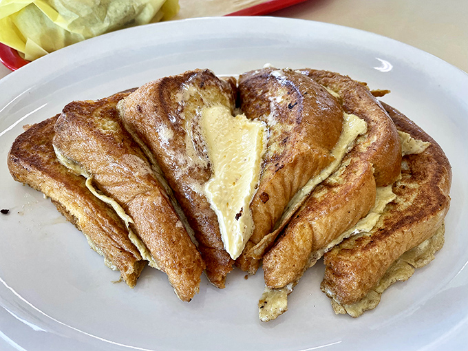 French toast cut into triangles and stacked like delicious dominoes—breakfast architecture at its most delicious.