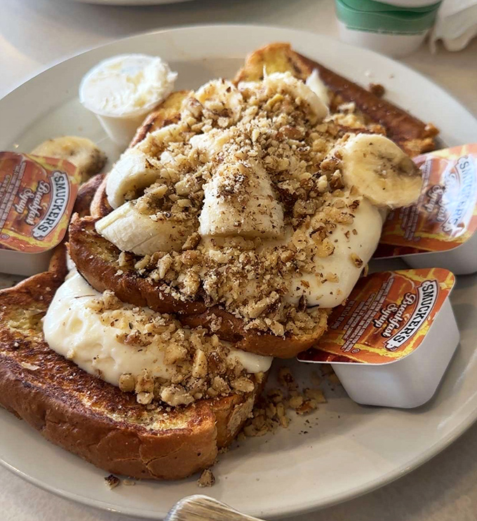 French toast that's dressed for success. Those bananas and crumbled nuts aren't just toppings—they're the supporting actors in this breakfast blockbuster.