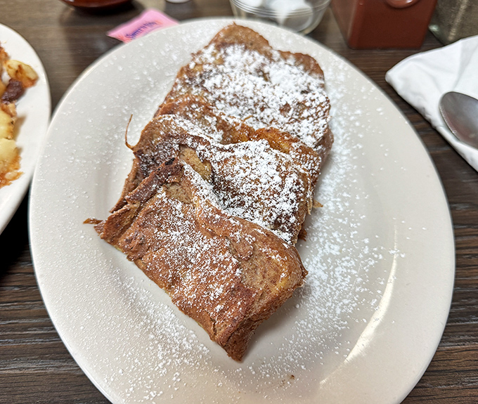 French toast that doesn't need a passport to impress—just the perfect dusting of powdered sugar and the confidence to let simplicity shine.