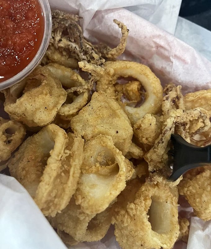 Crispy calamari rings with marinara – proof that Dog House Grill knows its way around the fryer too.