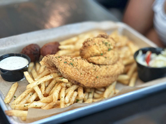 Golden-fried perfection meets French fry abundance—proof that sometimes the simplest preparations create the most satisfying bites.