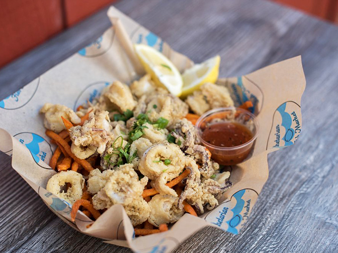 Calamari that's tender, not rubbery—the unicorn of fried seafood. Paired with those sweet potato fries, it's a match made in maritime heaven.