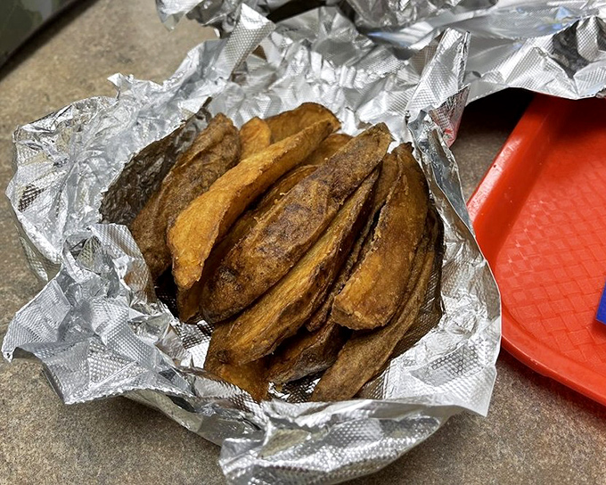 These aren't just fries—they're golden-brown potato treasures wrapped in foil like the precious artifacts they are. Worth every crispy calorie.